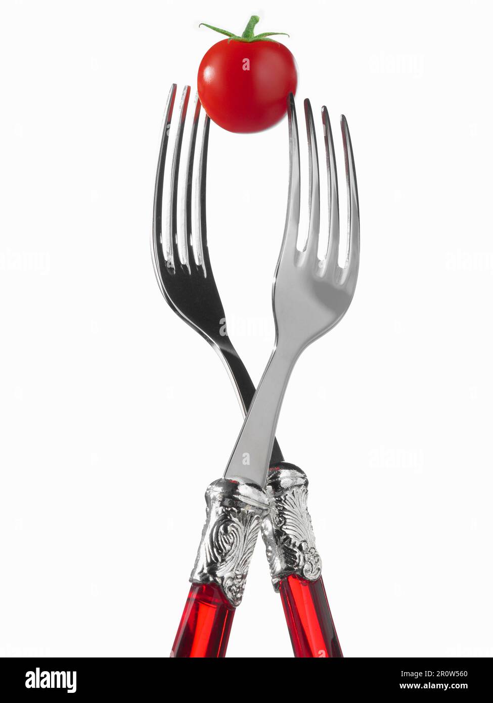 Two forks with cherry tomato Stock Photo - Alamy