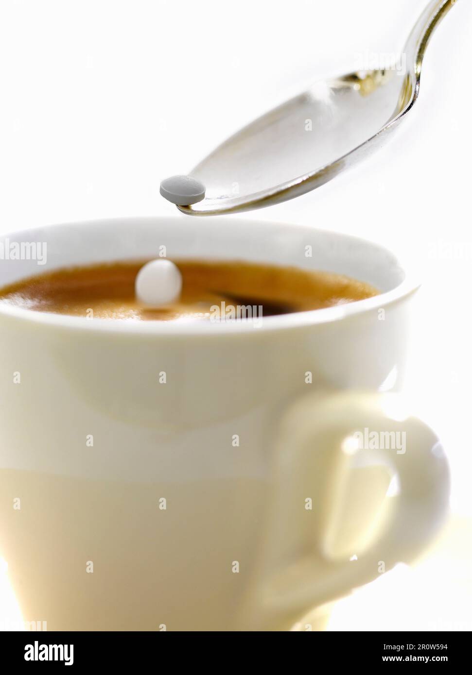 Adding artificial sweetener to a cup of expresso coffee Stock Photo - Alamy