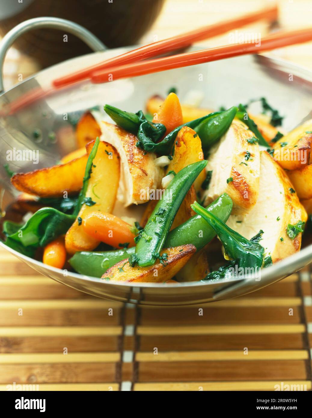 Chicken and spring vegetables cooked in a wok Stock Photo - Alamy