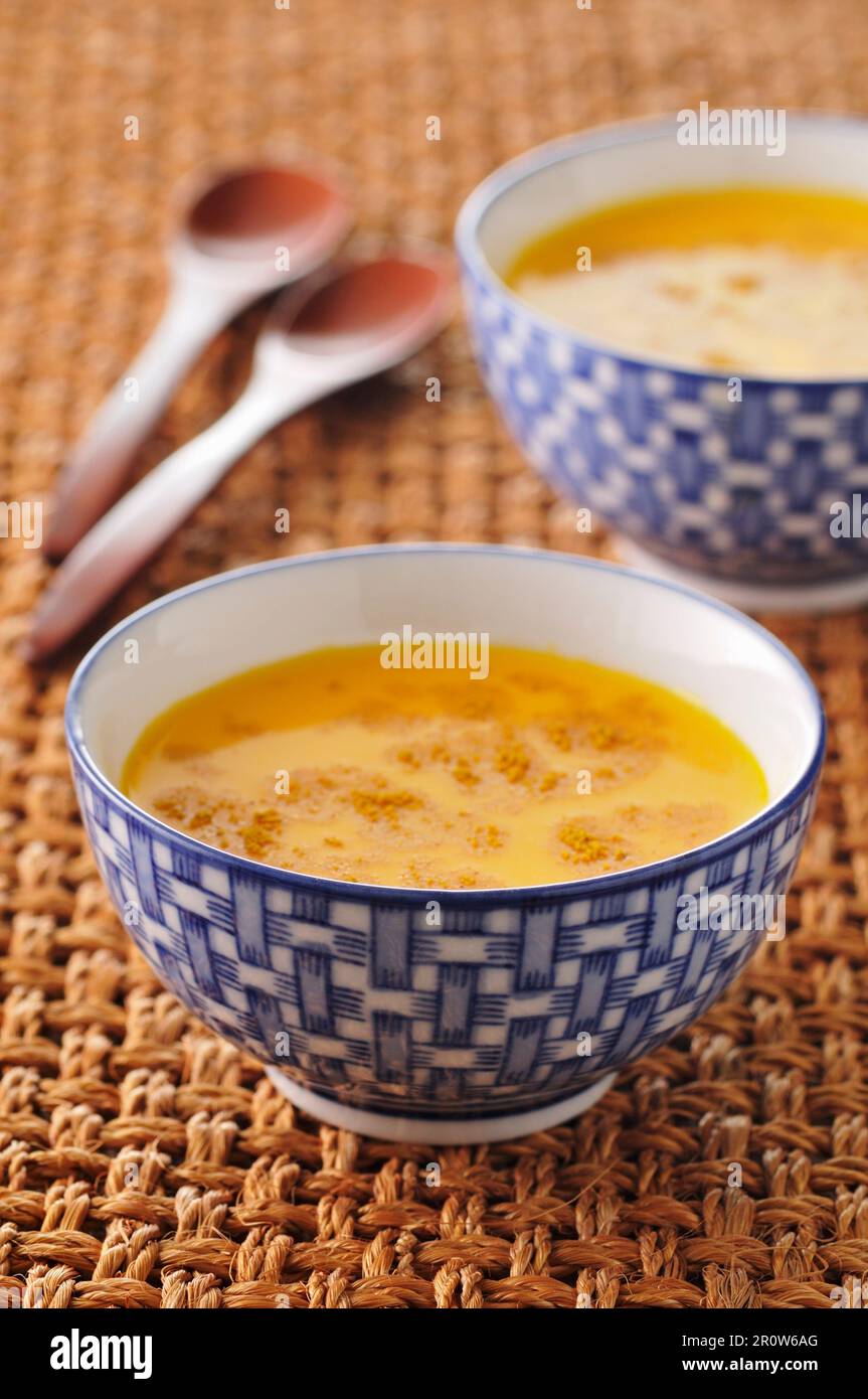 Cream of carrot,coconut milk and Madras curry soup Stock Photo - Alamy
