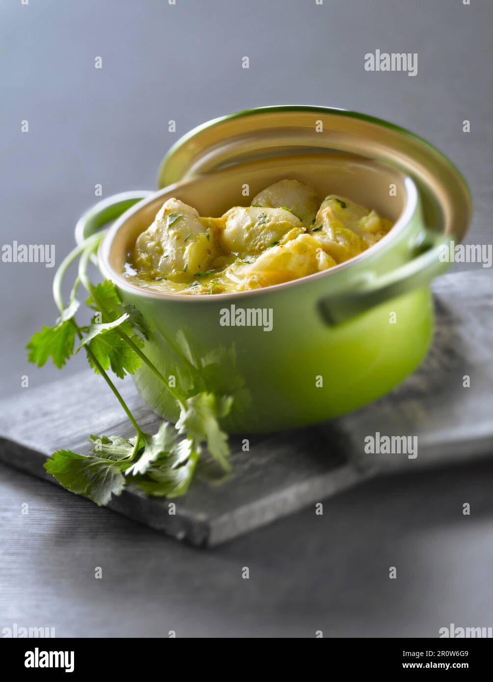 Casserole dish of monkfish with curry,coconut milk and coriander Stock ...