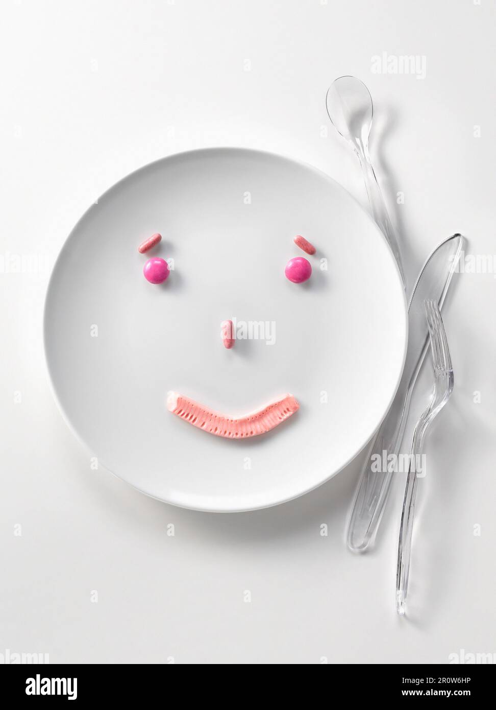 Plate of pink candies in the shape of a face Stock Photo - Alamy