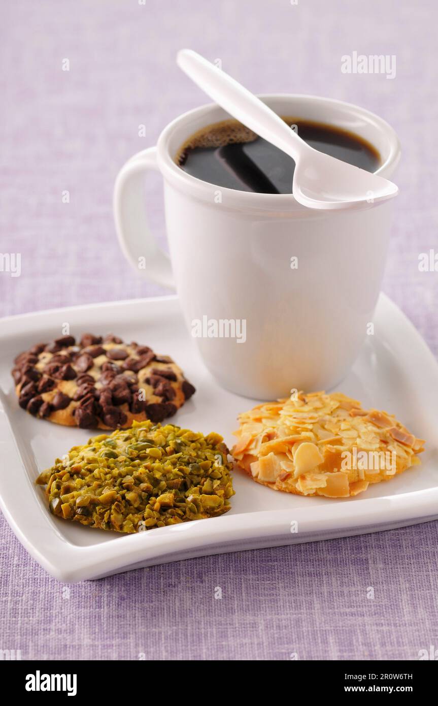 Cup of coffee and three different flavored crunchy cookies Stock Photo ...