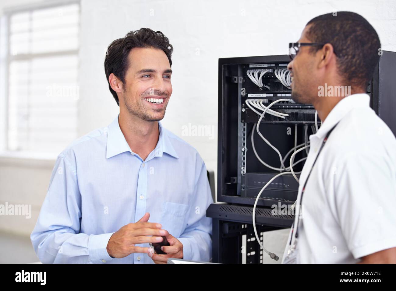 Server room, it support and maintenance with a technician talking to a ...