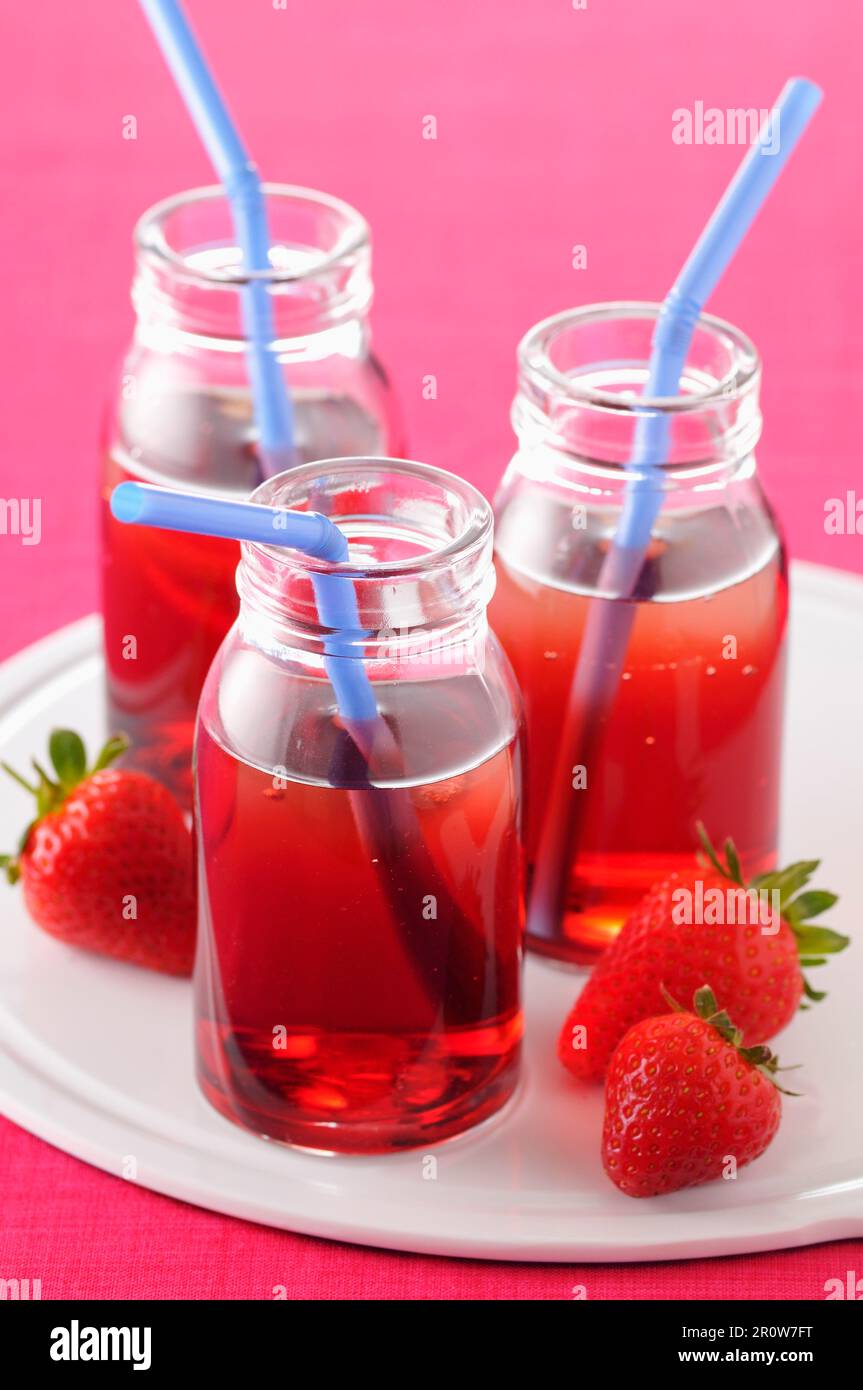 Small bottles of strawberry cordial Stock Photo - Alamy