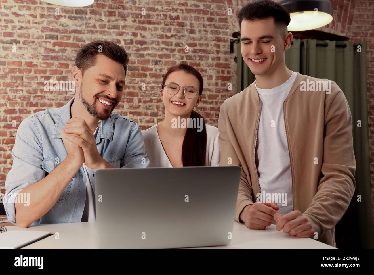 Team of employees working together in office Stock Photo - Alamy