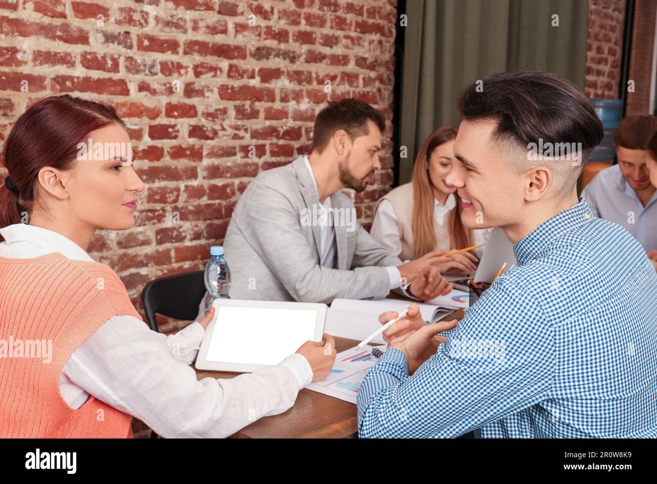 Team of employees working together in office Stock Photo - Alamy