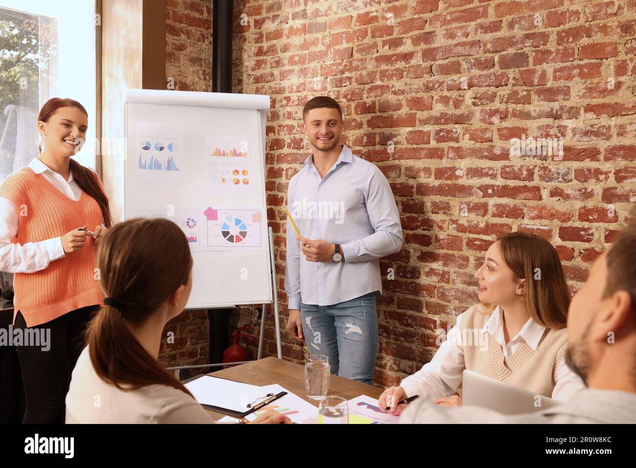 Employees having meeting in office. Team work Stock Photo - Alamy
