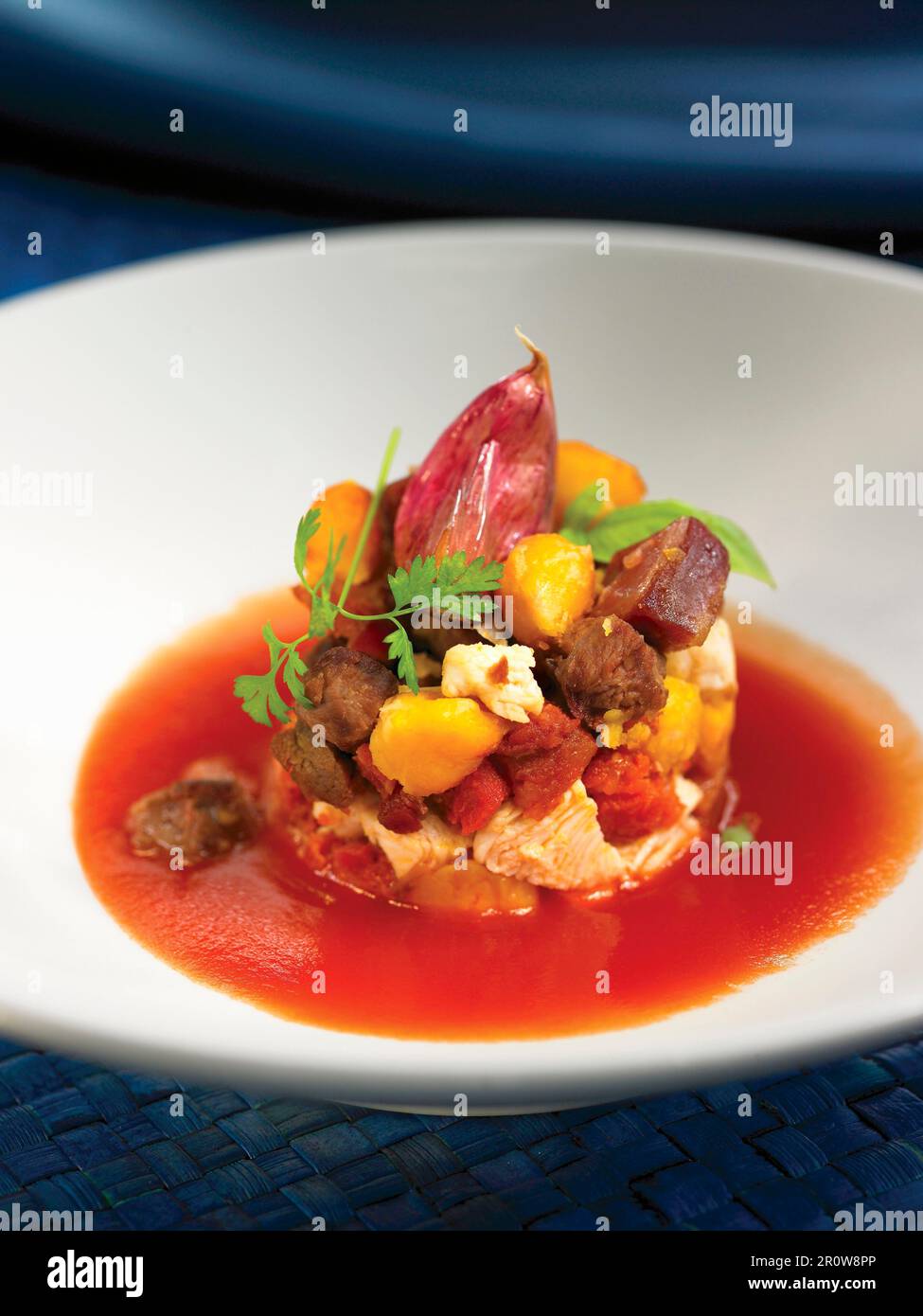 Braised beef, ham, blood sausage and Chorizo tumbler in tomato sauce ...