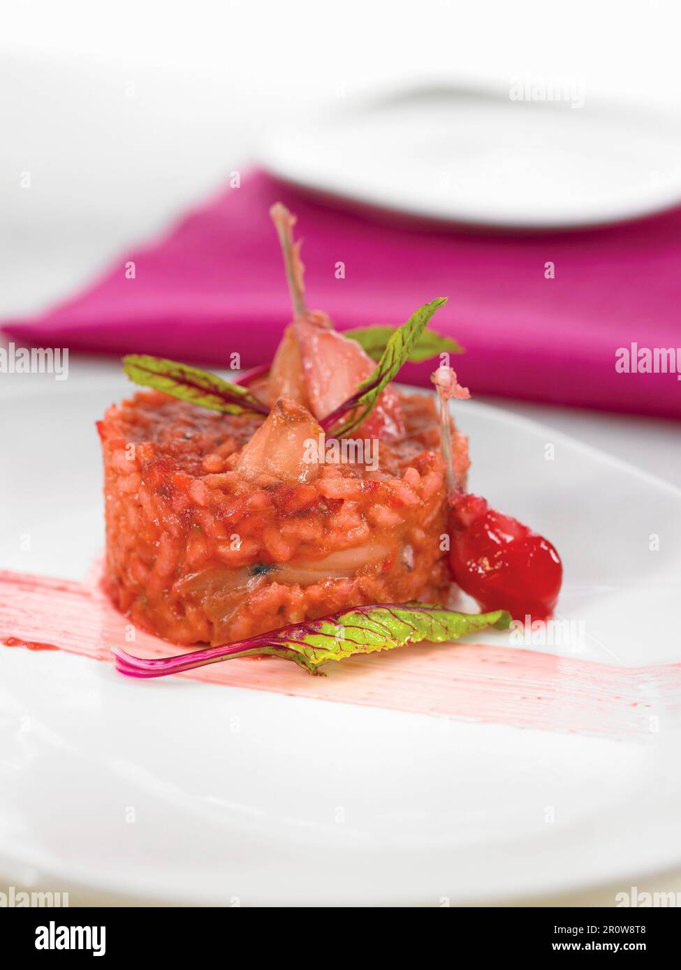 Beetroot-flavored rice with frog's legs Stock Photo - Alamy
