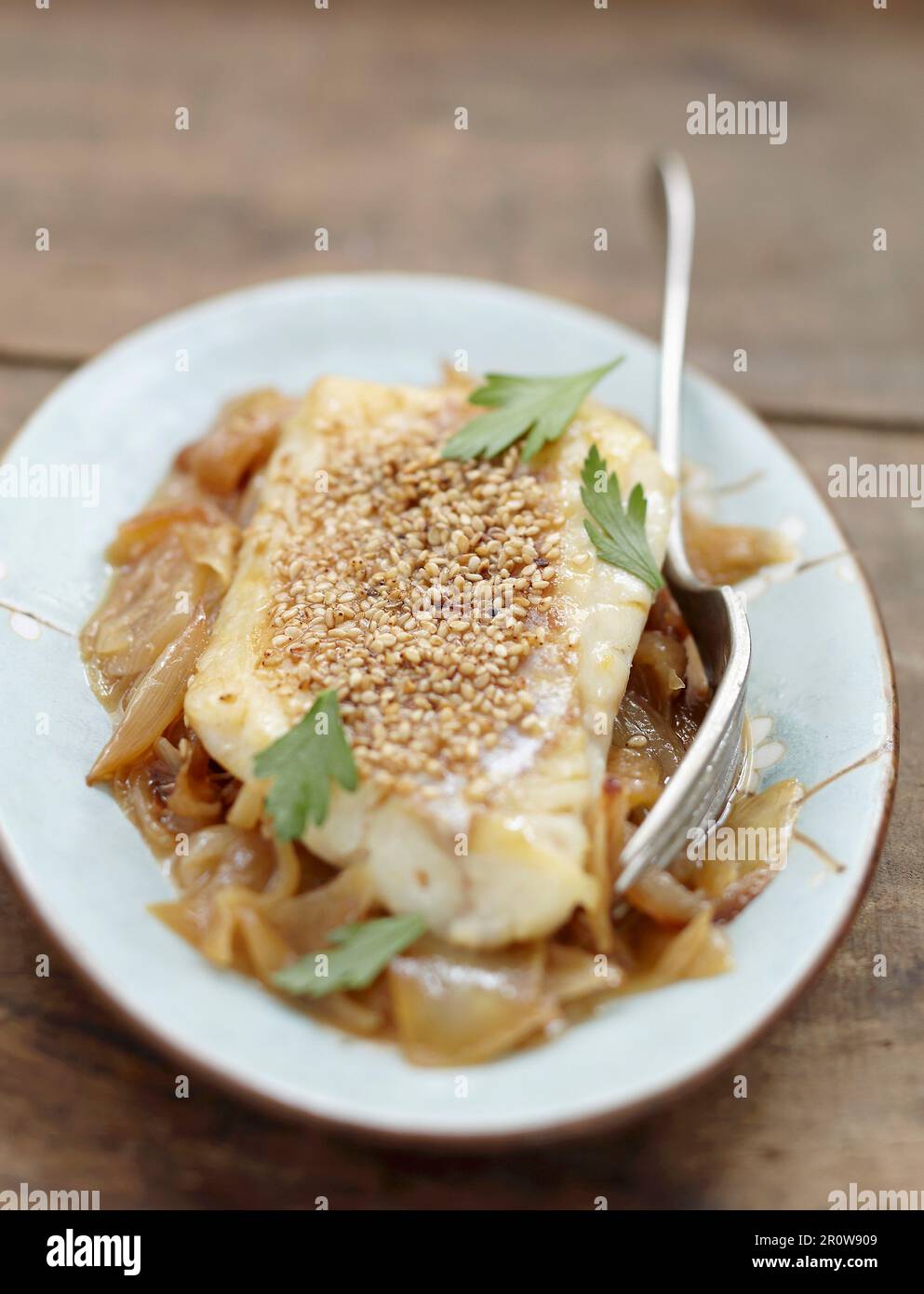 Cod with sesame seeds and onions Stock Photo - Alamy