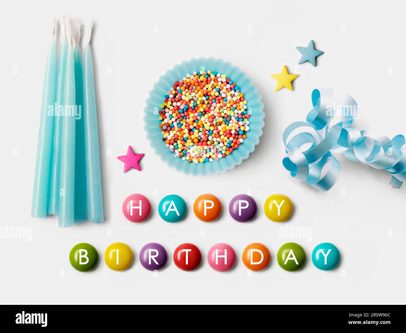 'Happy Birthday' written on Smarties and a blue paper cup full of sugar ...