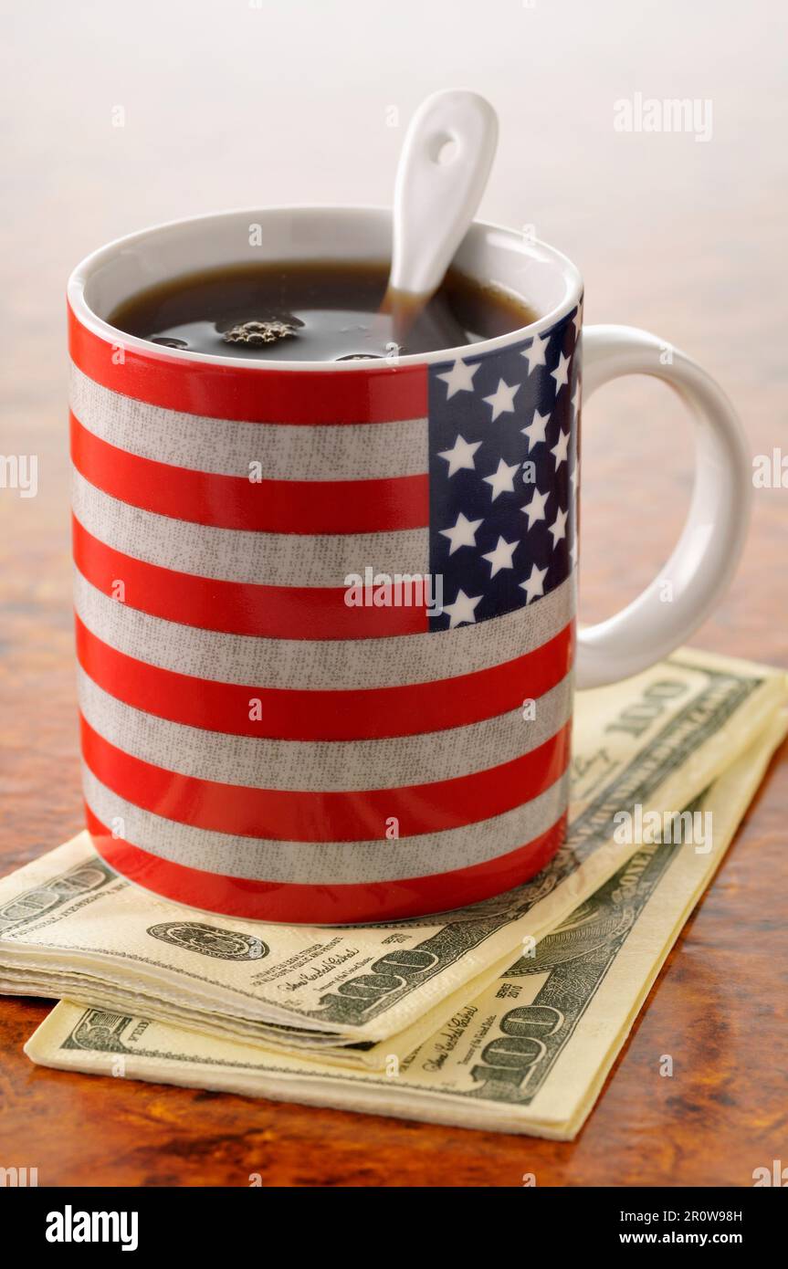 Cup of coffee in a mug with the American flag on it and dollar bills ...