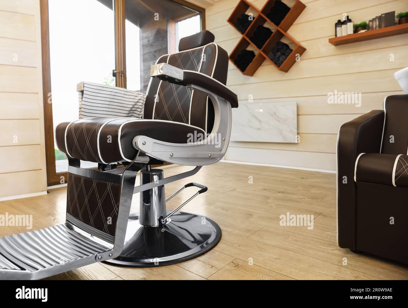 Stylish barbershop interior with professional armchair and modern wash ...