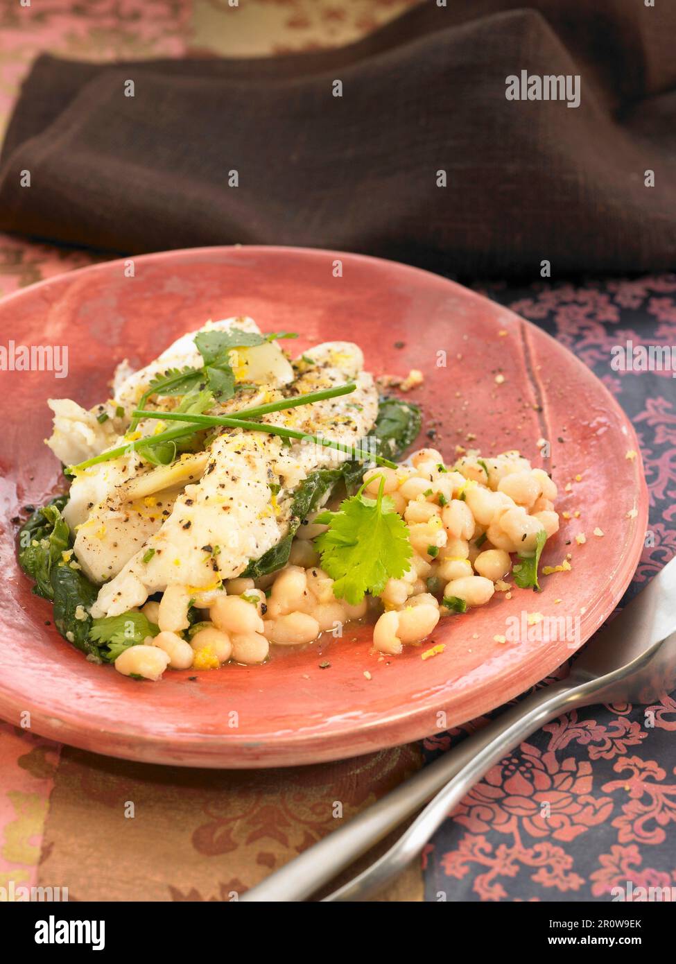 Salt-cod with spinach, white beans and fresh herbs Stock Photo - Alamy