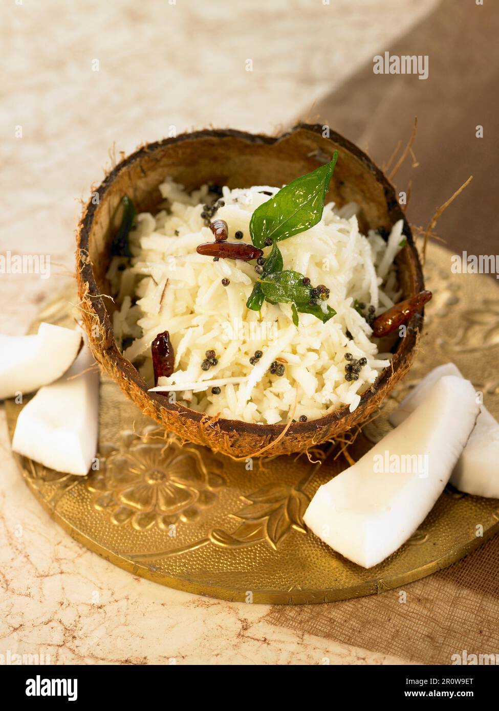 Rice with coconut, chili peppers and mustard seeds Stock Photo - Alamy