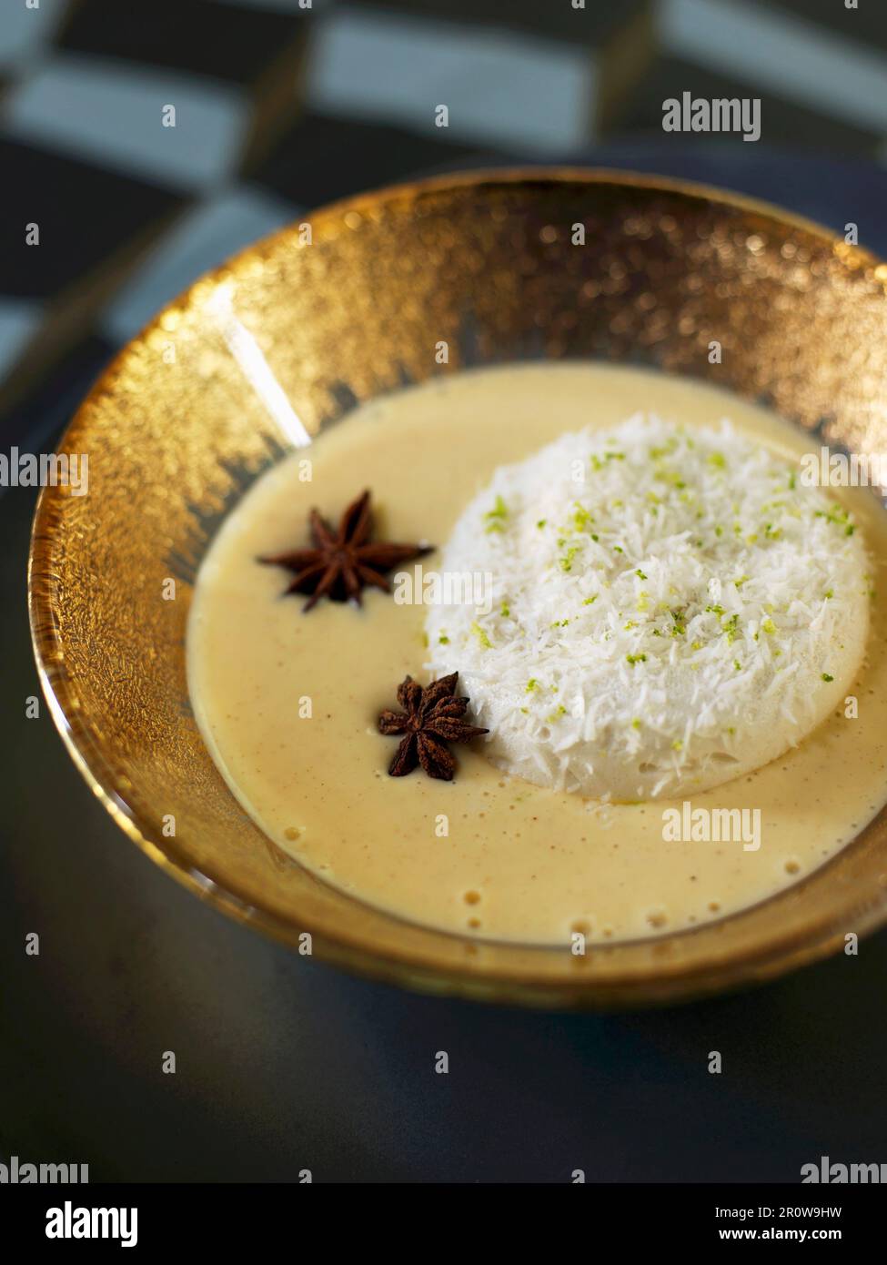 Coconut floating island with star anise-flavored custard Stock Photo ...