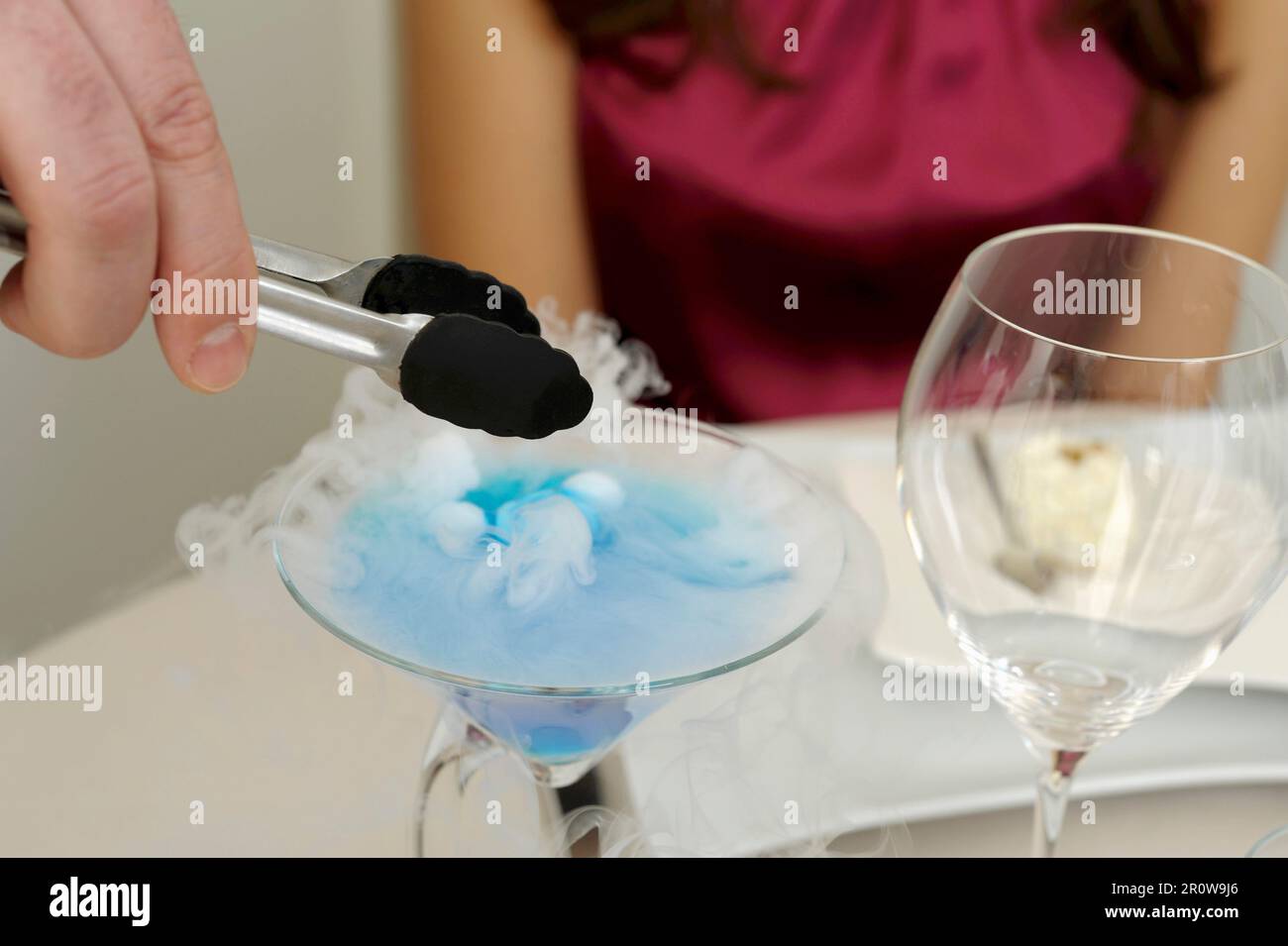 Preparing and serving a cocktail with dry ice Stock Photo - Alamy