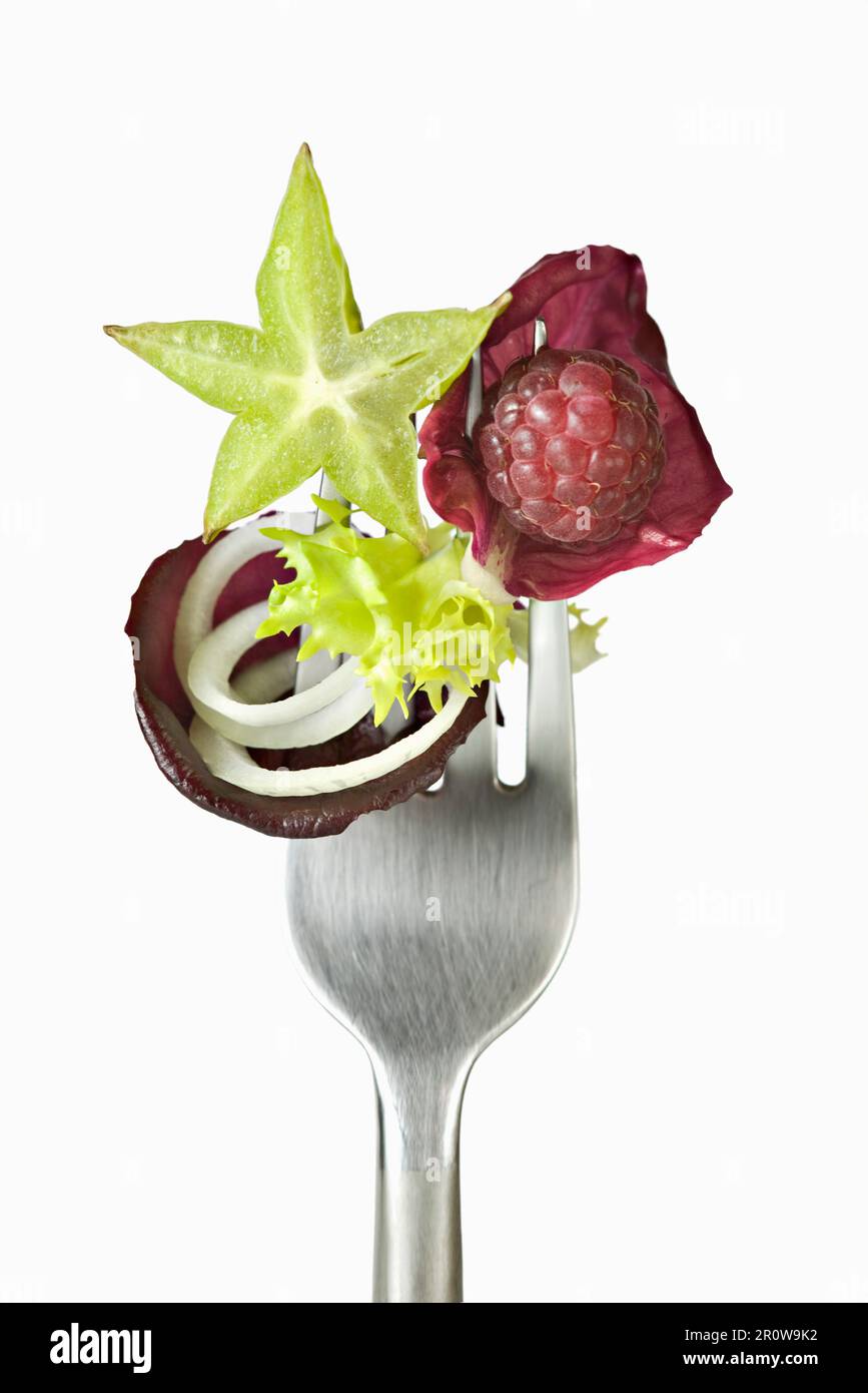 Fruit and vegetables on a fork Stock Photo - Alamy