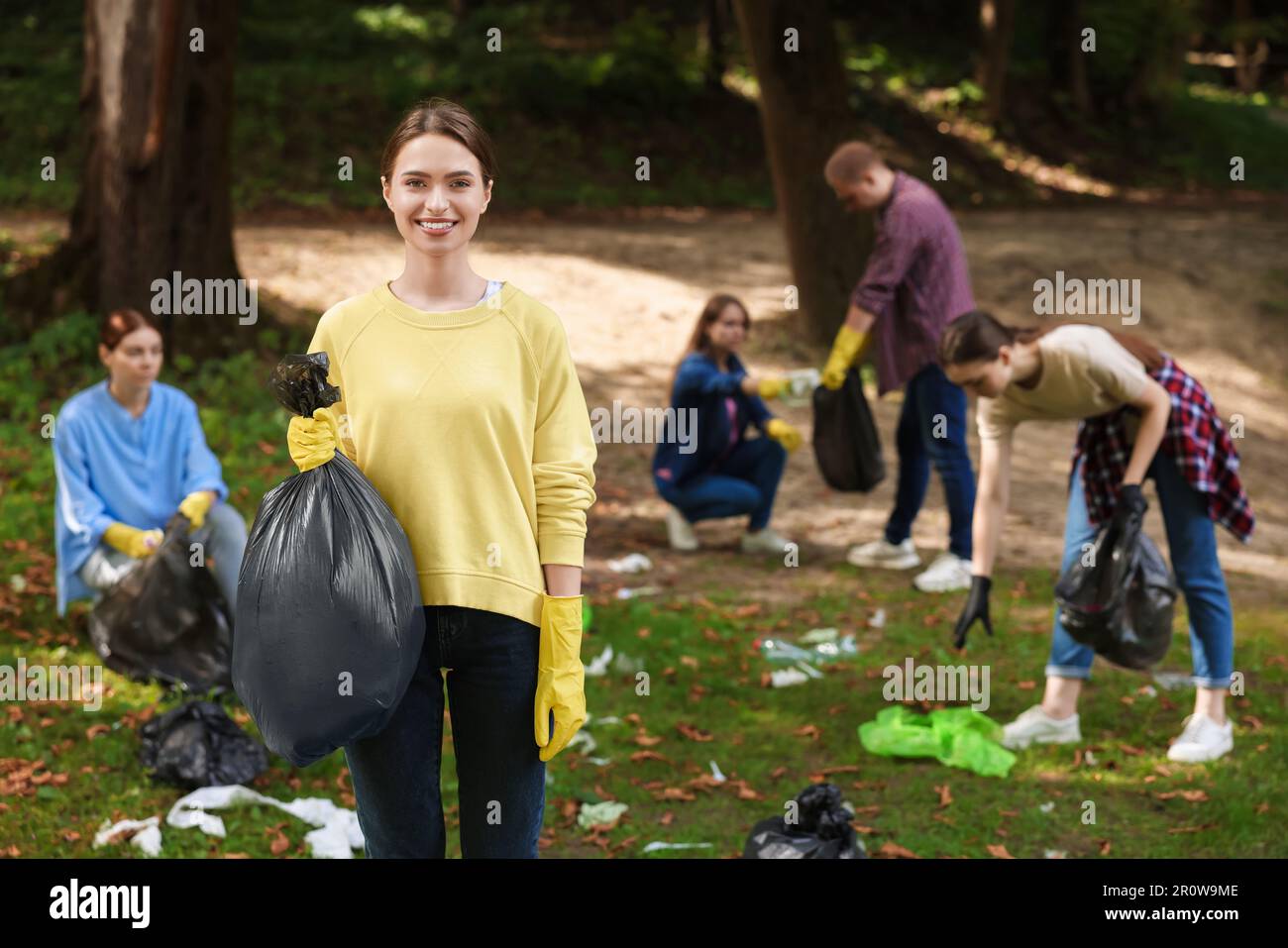 Young people collecting garbage hi-res stock photography and images - Alamy