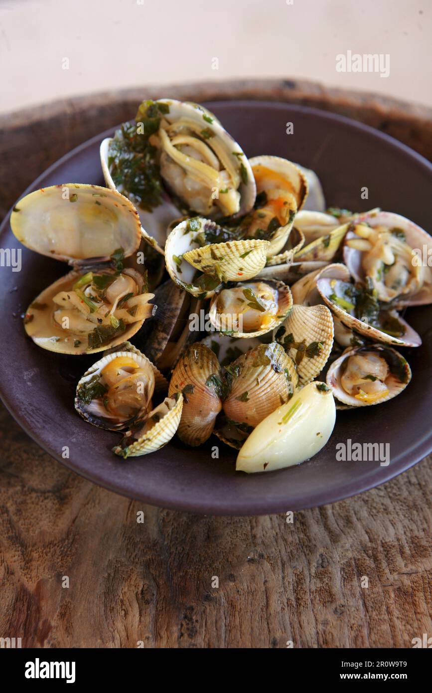 Shellfish sauté with herbs Stock Photo - Alamy