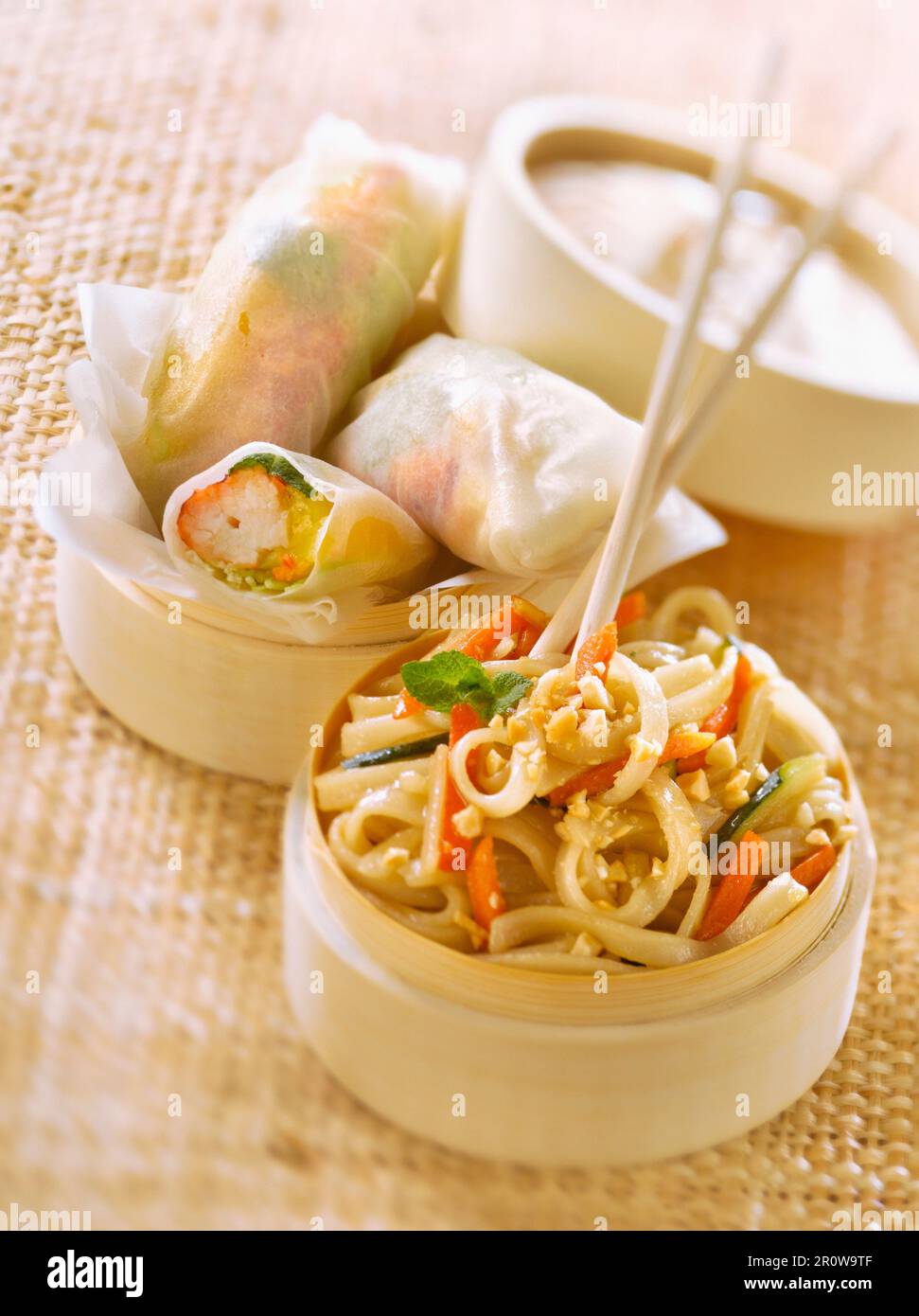 Spring rolls with crab meat and fried noodles with carrot, courgette ...