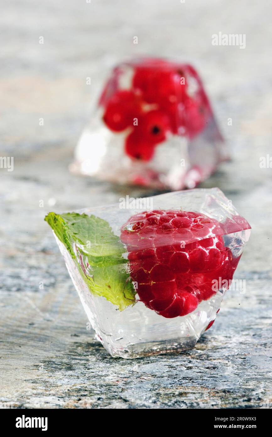 Ice cube with a raspberry Stock Photo - Alamy