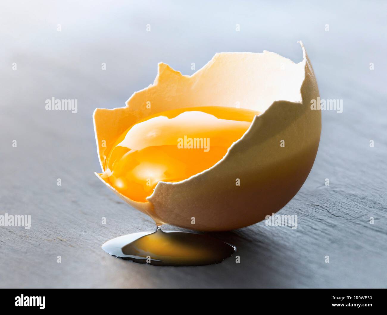 Egg yolk in half an egg shell Stock Photo - Alamy