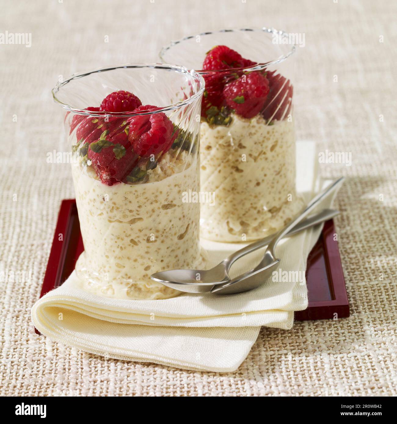 Vanilla quinoa pudding with raspberries and pistachios Stock Photo - Alamy