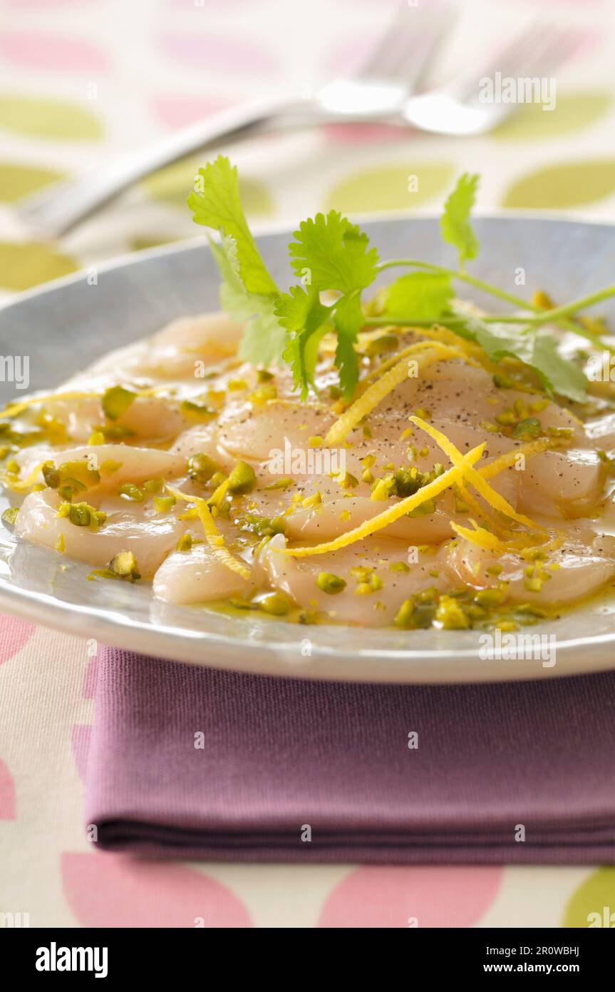 SCallop carpaccio with pistchios Stock Photo - Alamy