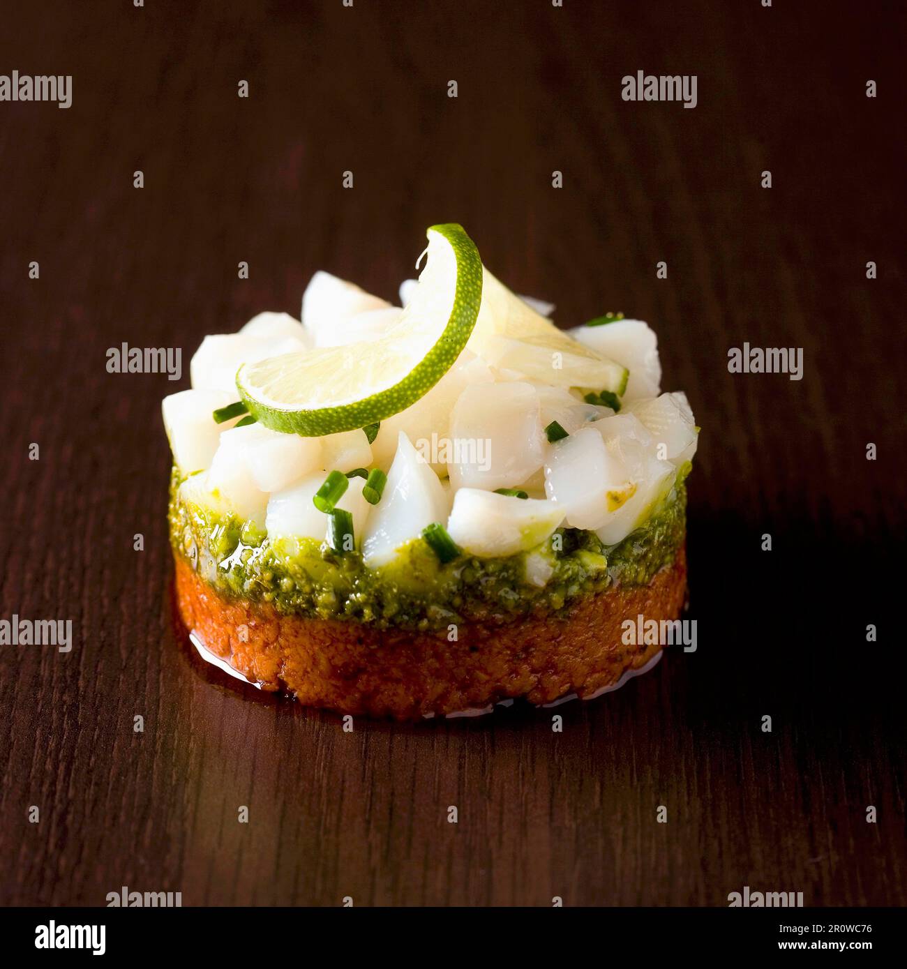 Scallops marinated in lime juice, pesto and tomato caviar Timbale Stock ...