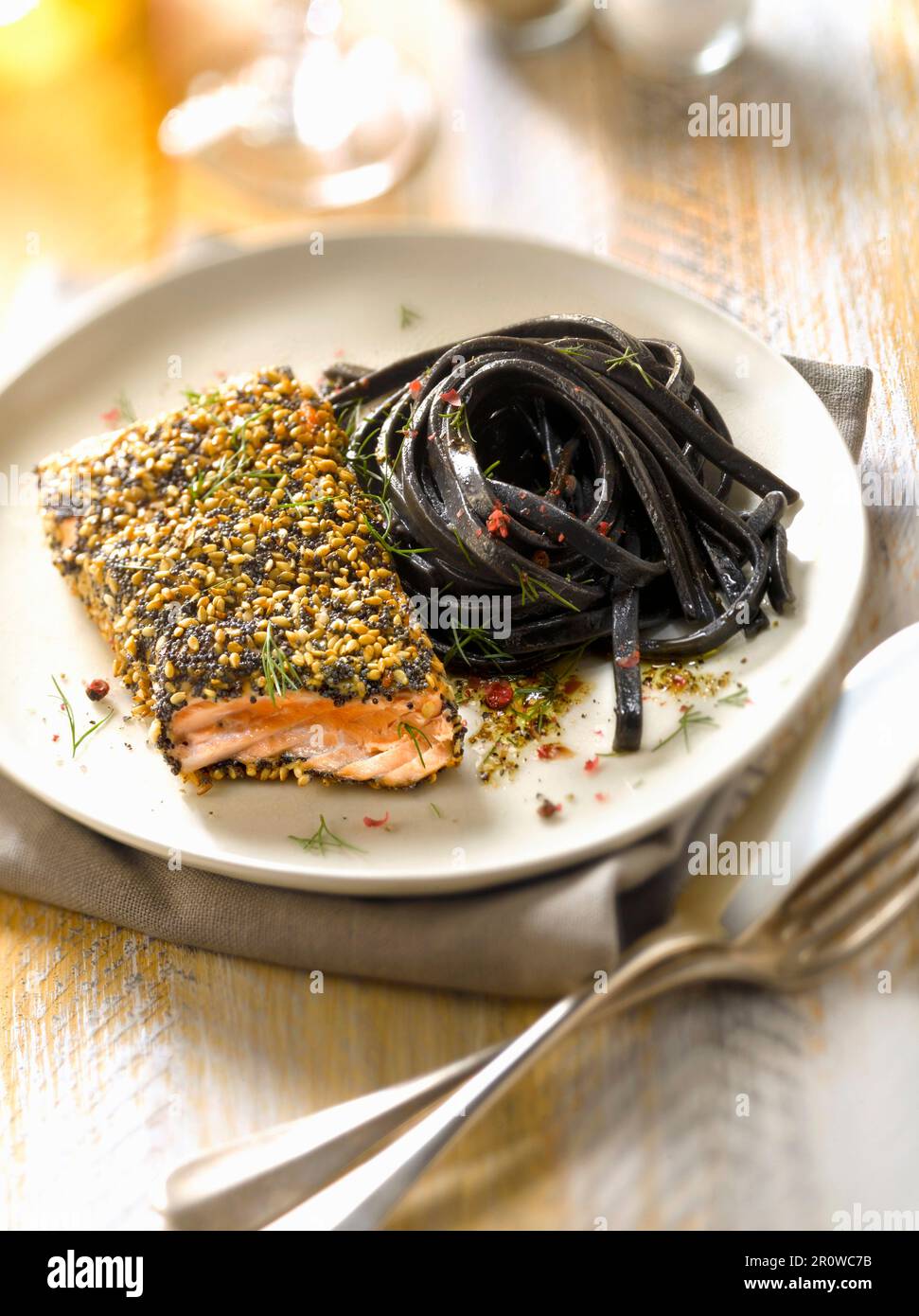 Salmon steak in sesame and poppy seed crust,squid ink spaghettis Stock ...