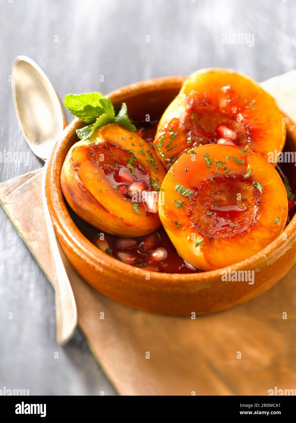 Nectarines roasted in pomegranate syrup Stock Photo - Alamy