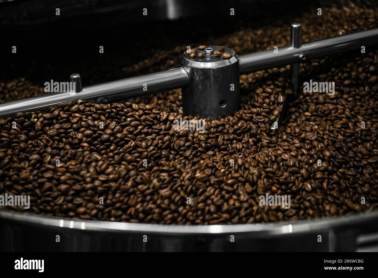 Modern coffee roaster machine with beans, closeup Stock Photo - Alamy