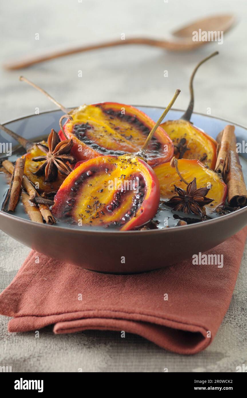 Tamarillos poached in spicy red wine Stock Photo - Alamy