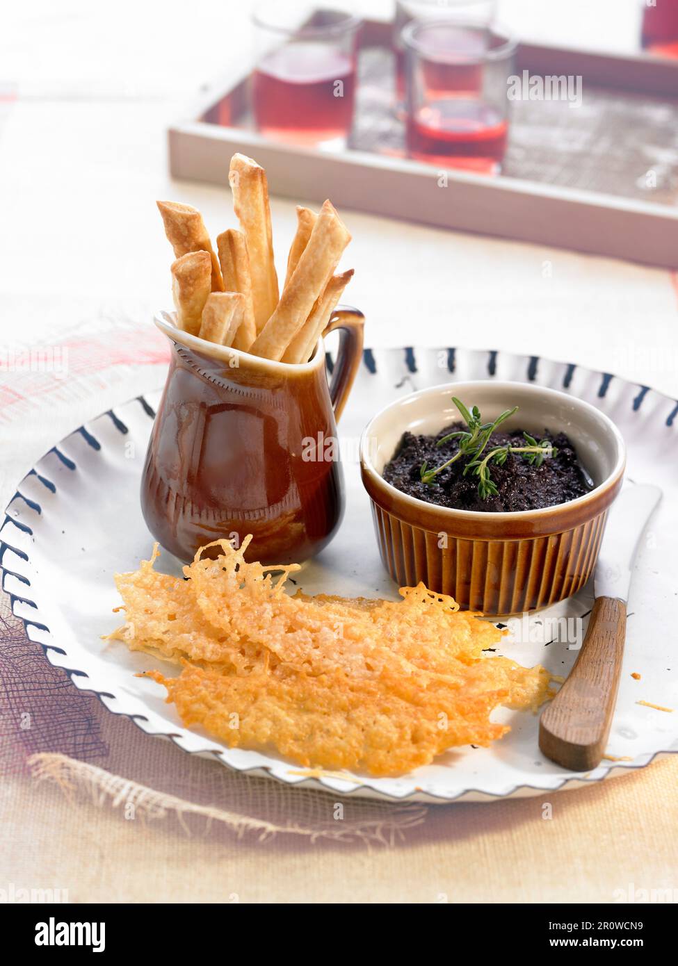 Homemade tapenade with cheese tuiles and bread sticks Stock Photo - Alamy