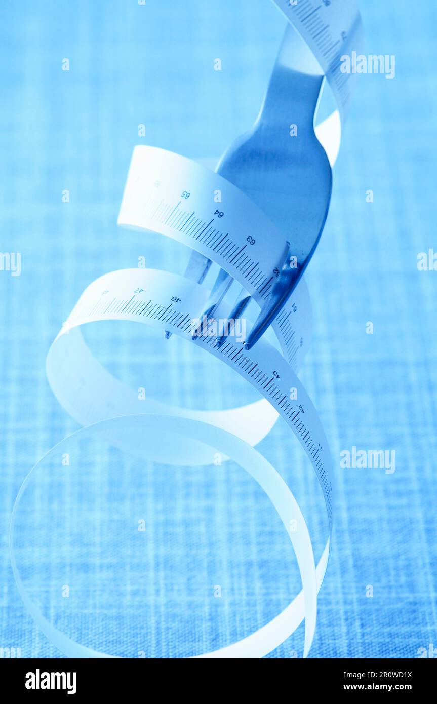 Measuring tape wrapped around a fork Stock Photo - Alamy