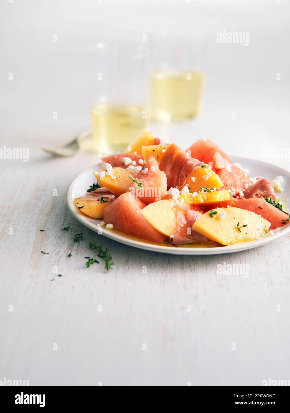 Melon, watermelon, raw ham and crumbled feta salad Stock Photo - Alamy