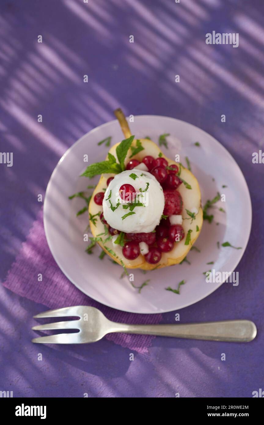 Pears with red berries,lemon sorbet and fresh mint Stock Photo - Alamy