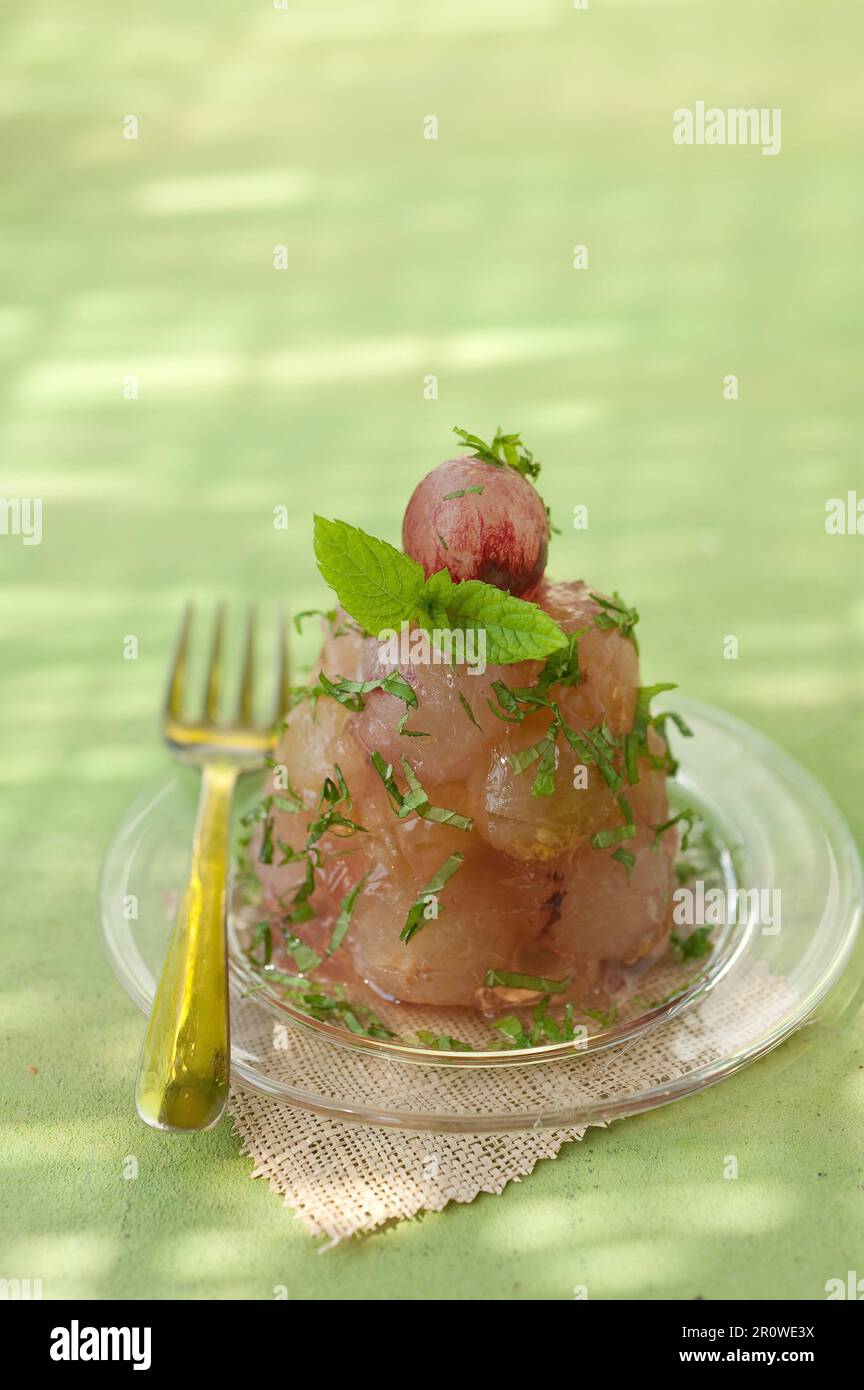 Grapes with lemon and lime in mild wine and mint jelly Stock Photo - Alamy