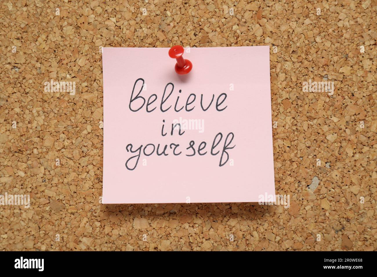 Note with phrase Believe In Yourself pinned on corkboard. Motivational ...