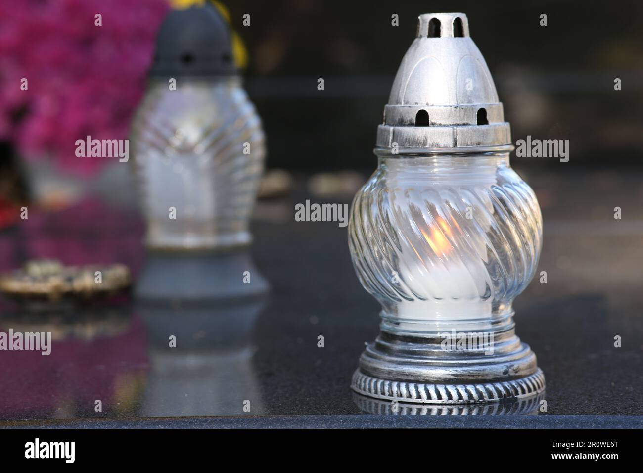 Grave lanterns on granite surface in cemetery, space for text Stock Photo - Alamy