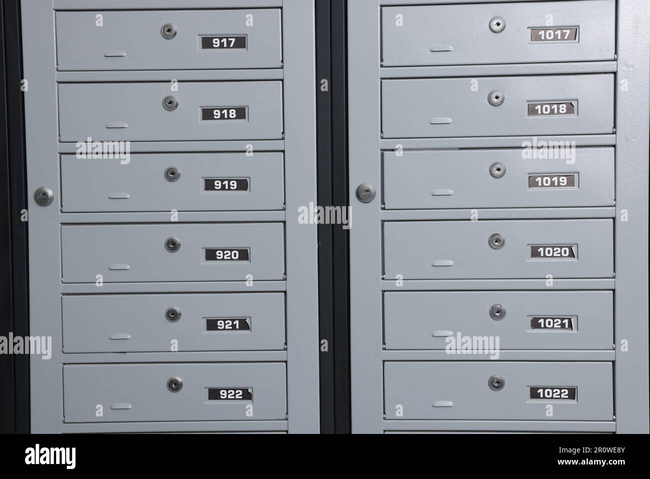 Closed metal mailboxes with keyholes and sequence numbers indoors Stock ...