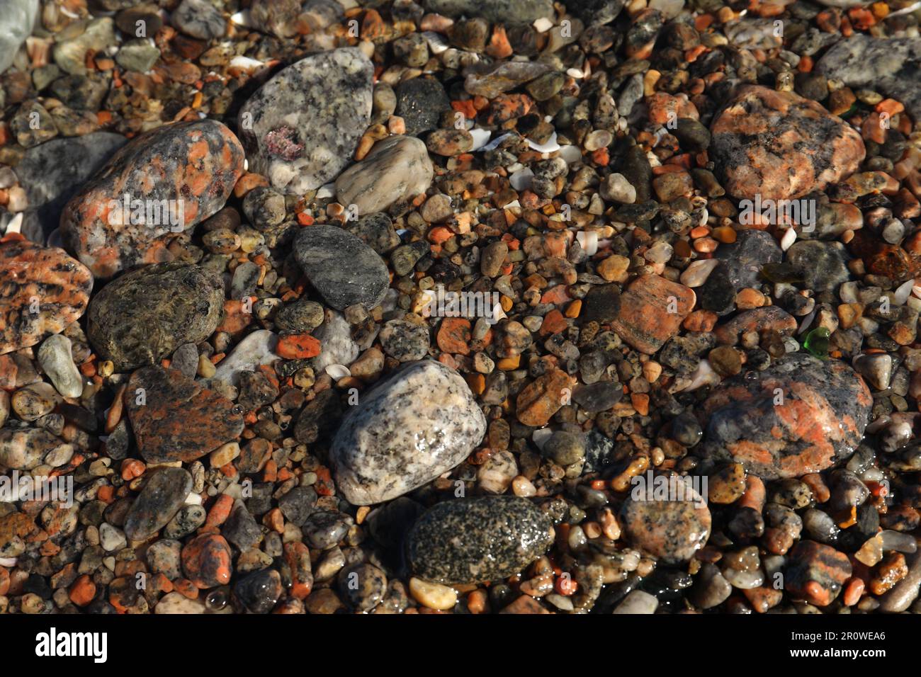 Beautiful pebbles in sea water as background, top view Stock Photo - Alamy