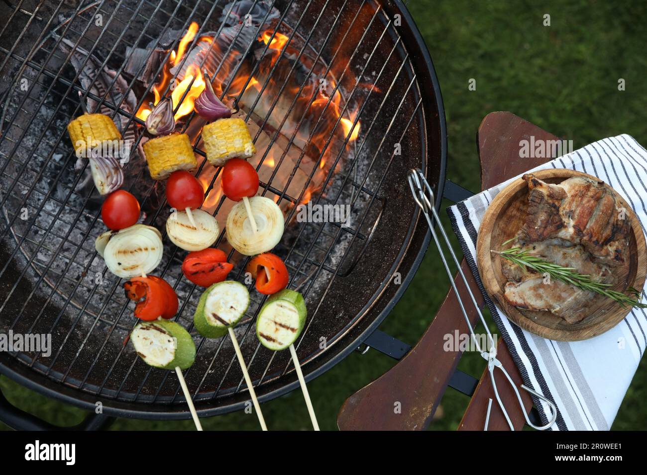Cooked food products and grill barbecue outdoors, top view Stock Photo ...
