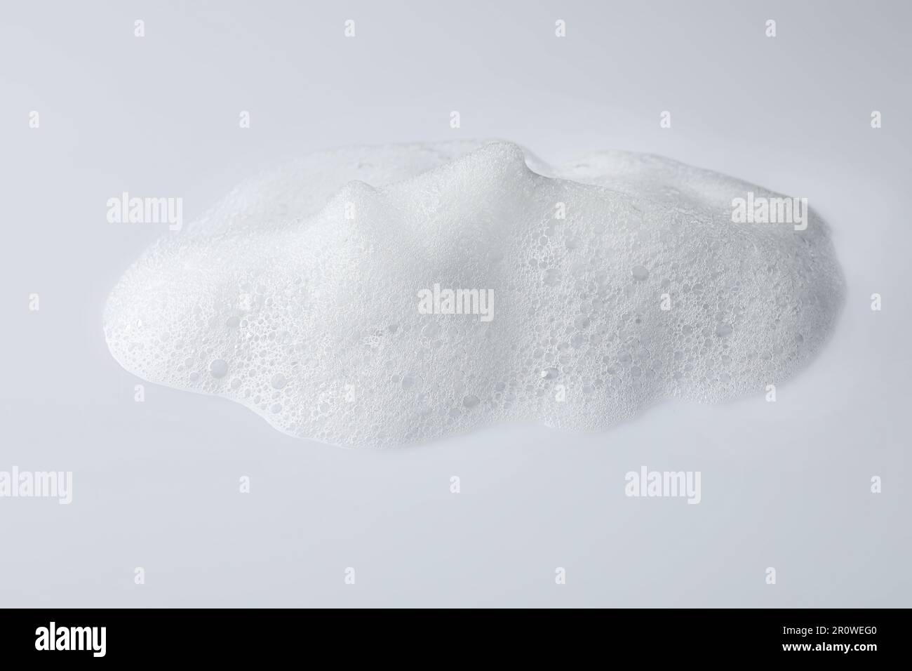 Drop of fluffy soap foam on white background Stock Photo - Alamy