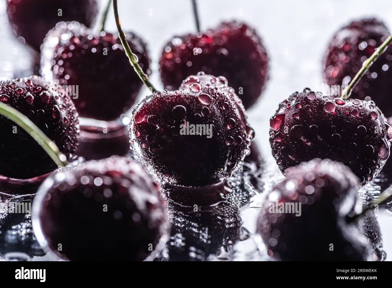 Red ripe cherries with water drops on wet surface Stock Photo - Alamy