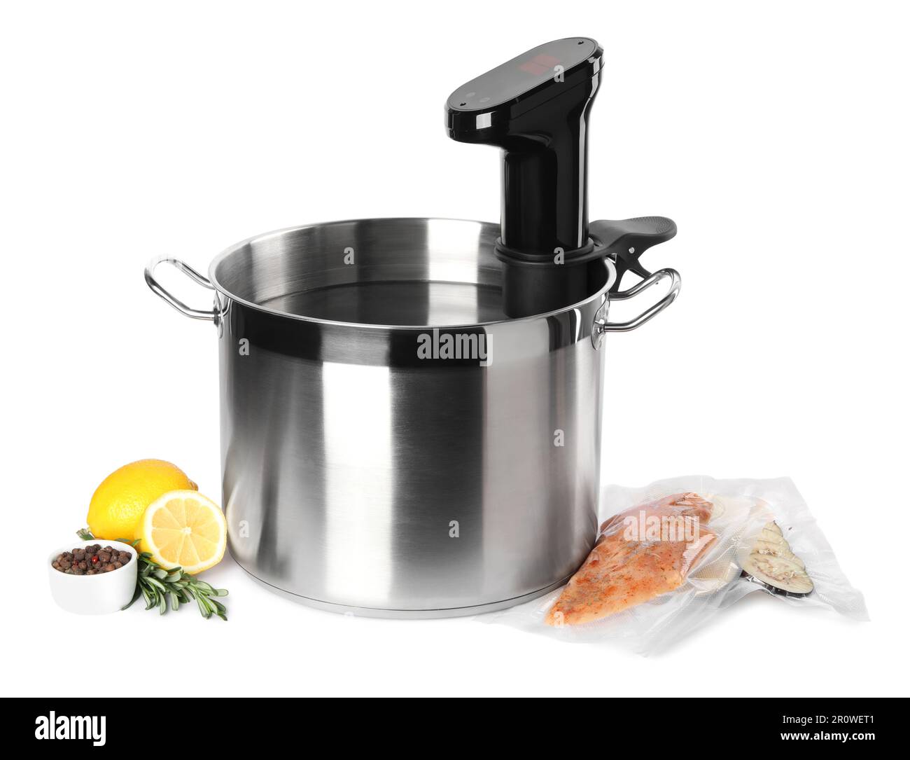 Thermal immersion circulator in pot and ingredients on white background ...