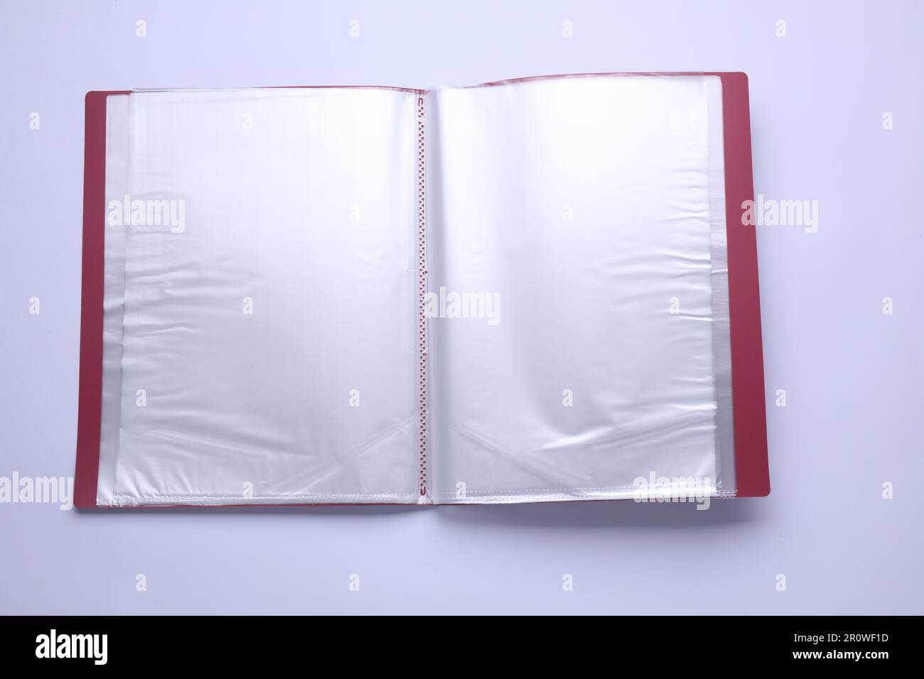 File folder with punched pockets and paper sheets isolated on white ...