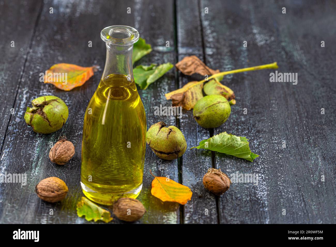 Bottle of vegetable oil surrounded by nuts Stock Photo - Alamy